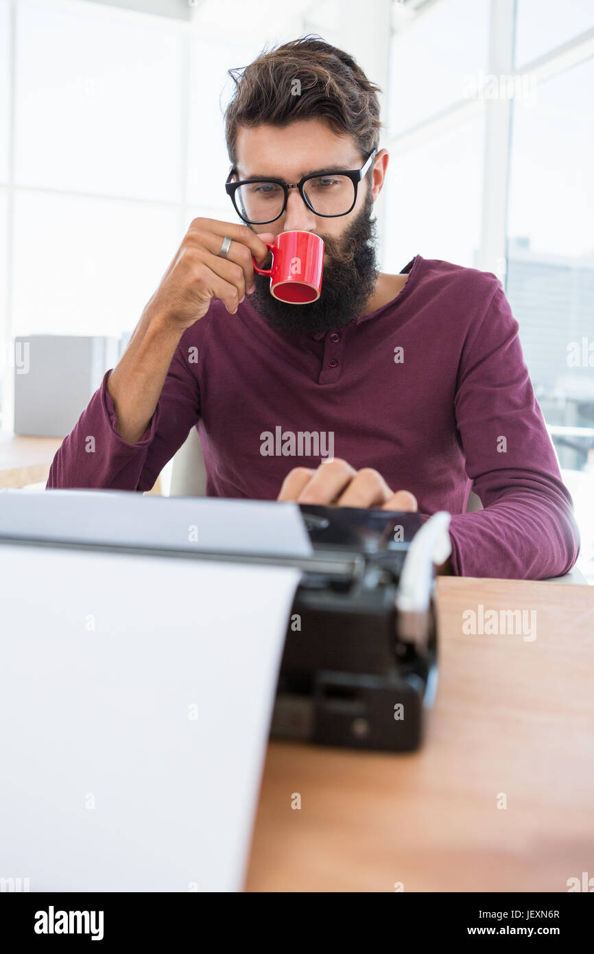 Hipster man using a typewriter Stock Photo - Alamy