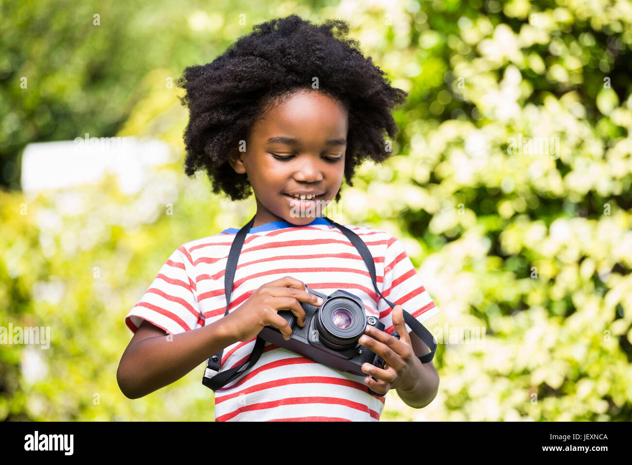 Boy looking at his camera Stock Photo - Alamy