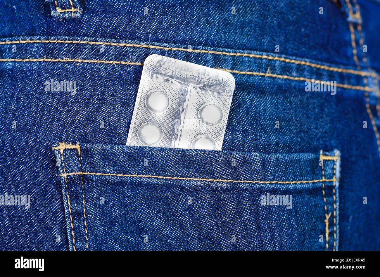 Silver tablet pills inside of jeans back pocket Stock Photo - Alamy