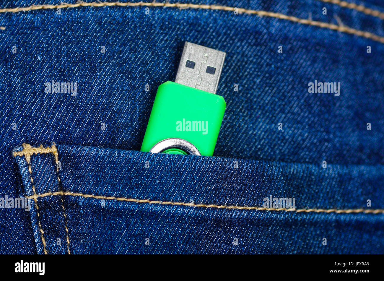 Green flash memory inside of jeans back pocket Stock Photo - Alamy