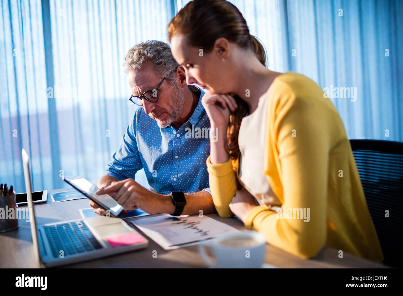 Two partners using tablet hi-res stock photography and images - Alamy