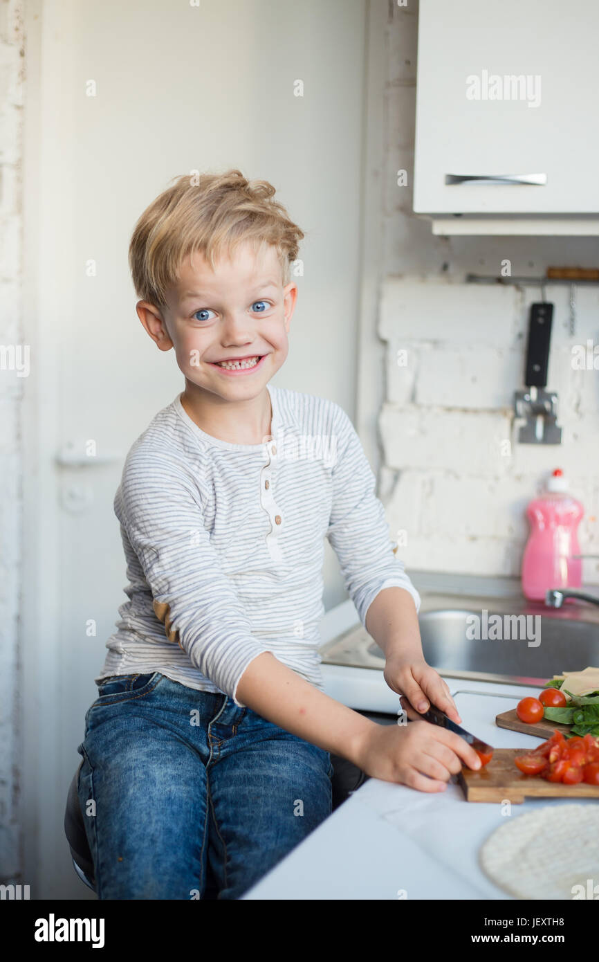 Kid chef is cooking in the kitchen at home. Healthy food Stock Photo ...