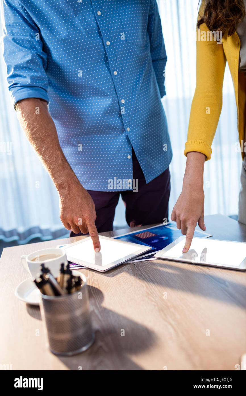 Businessmen using tablets computer Stock Photo - Alamy