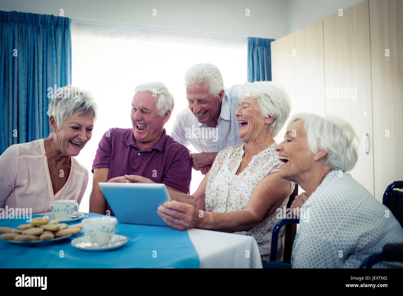 Group of seniors using a tablet computer Stock Photo - Alamy