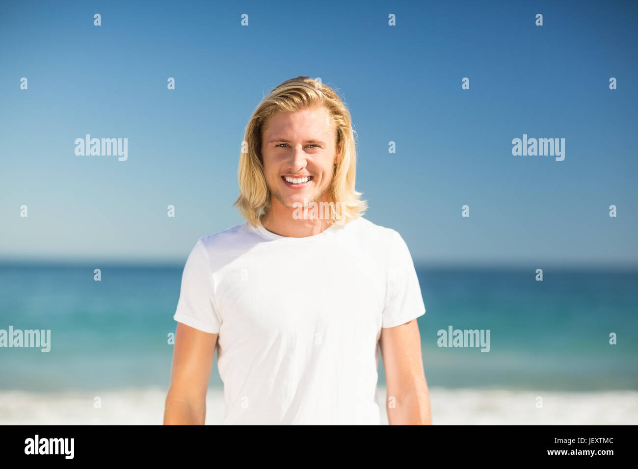 Man smiling on beach Stock Photo - Alamy