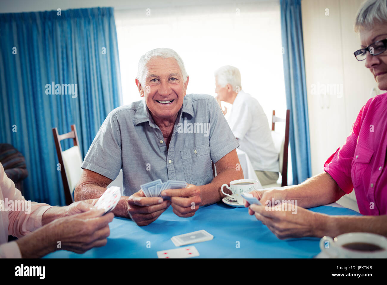 Group of seniors playing cards Stock Photo - Alamy