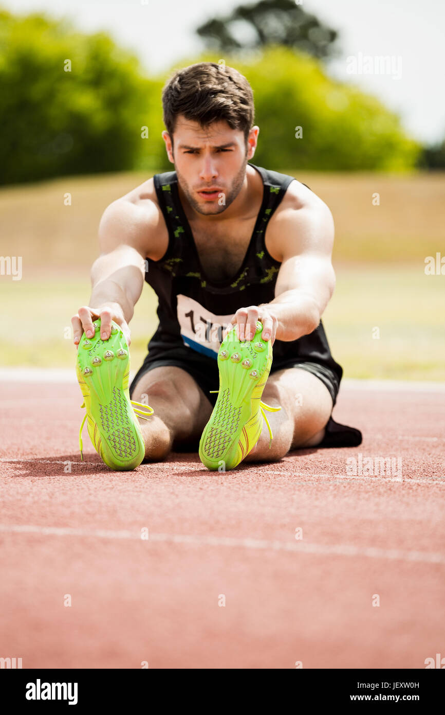 Athlete doing stretching exercise Stock Photo - Alamy