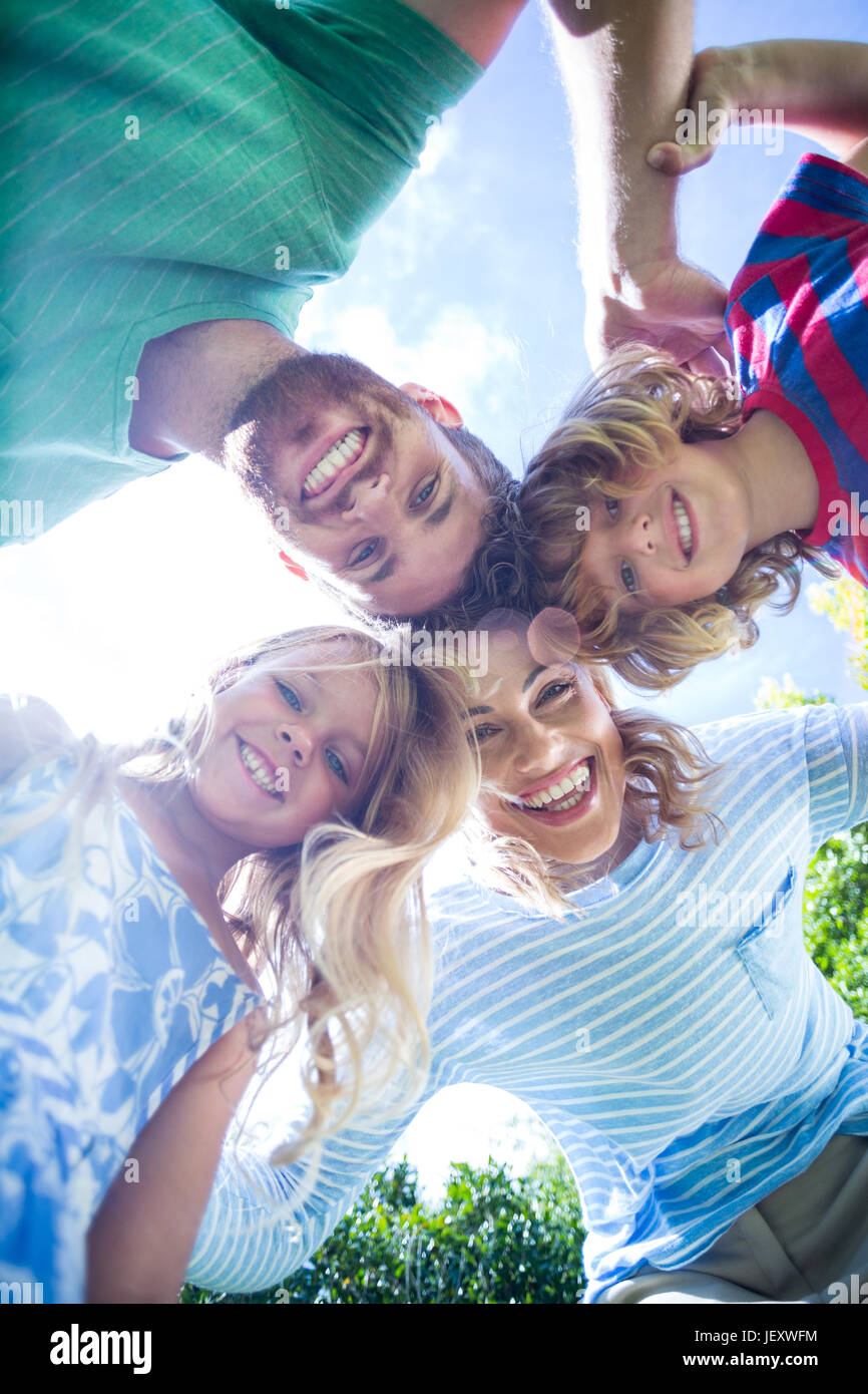 Family forming huddle in yard Stock Photo - Alamy