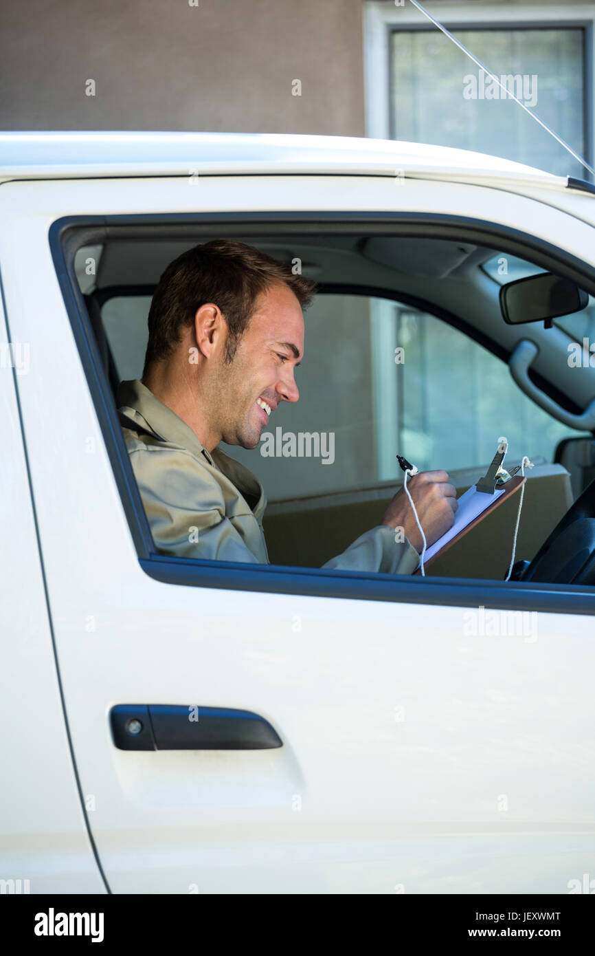 Delivery man sitting in his van Stock Photo - Alamy