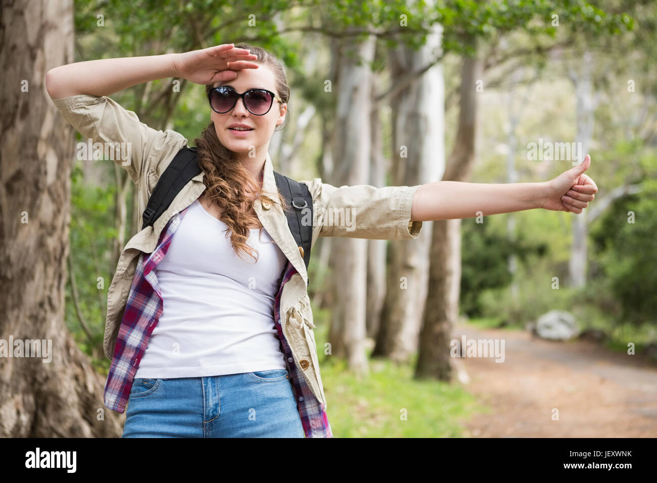 Portrait of woman hitch hiking Stock Photo - Alamy