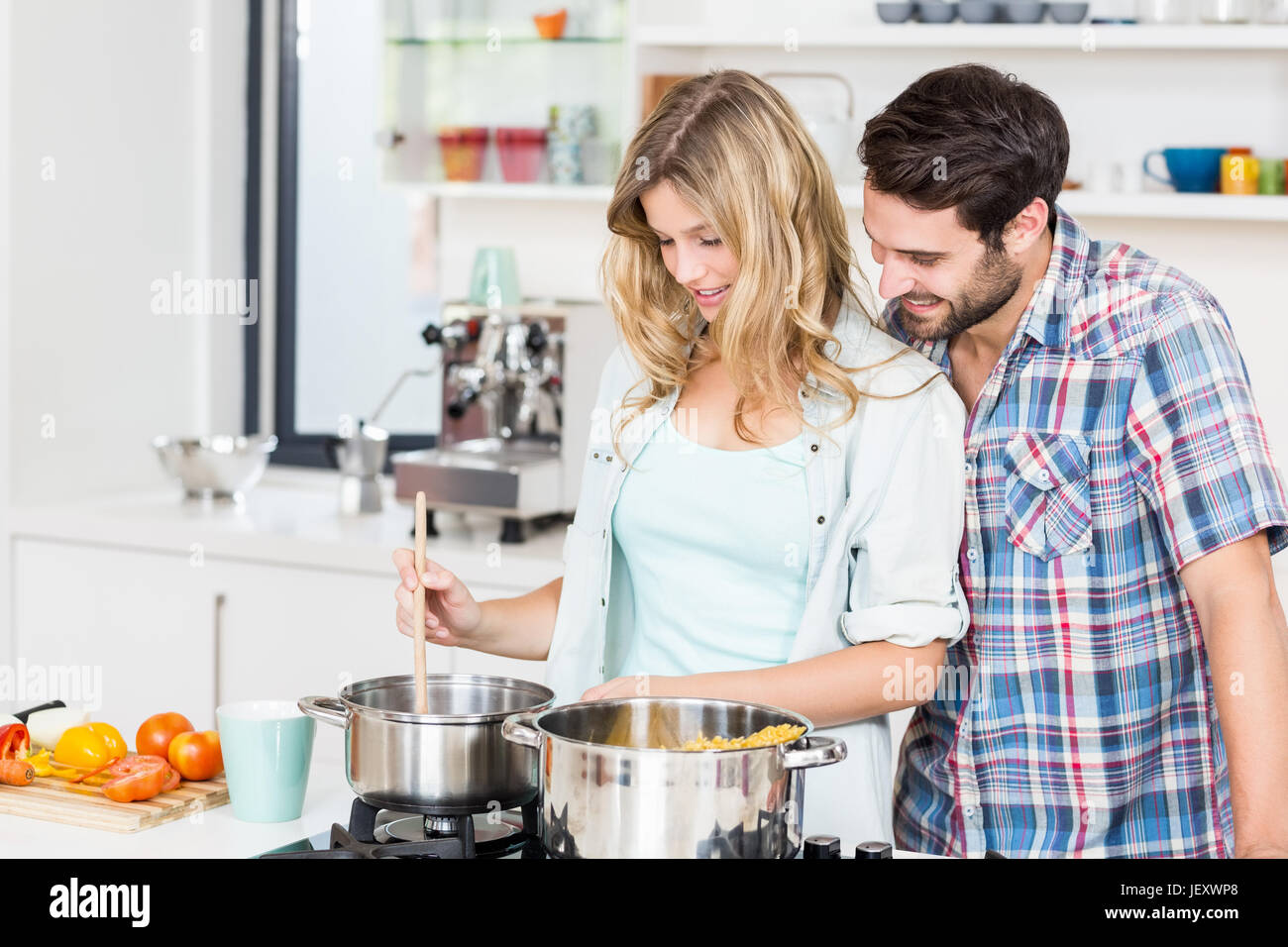 Young couple in the kitchen Stock Photo - Alamy