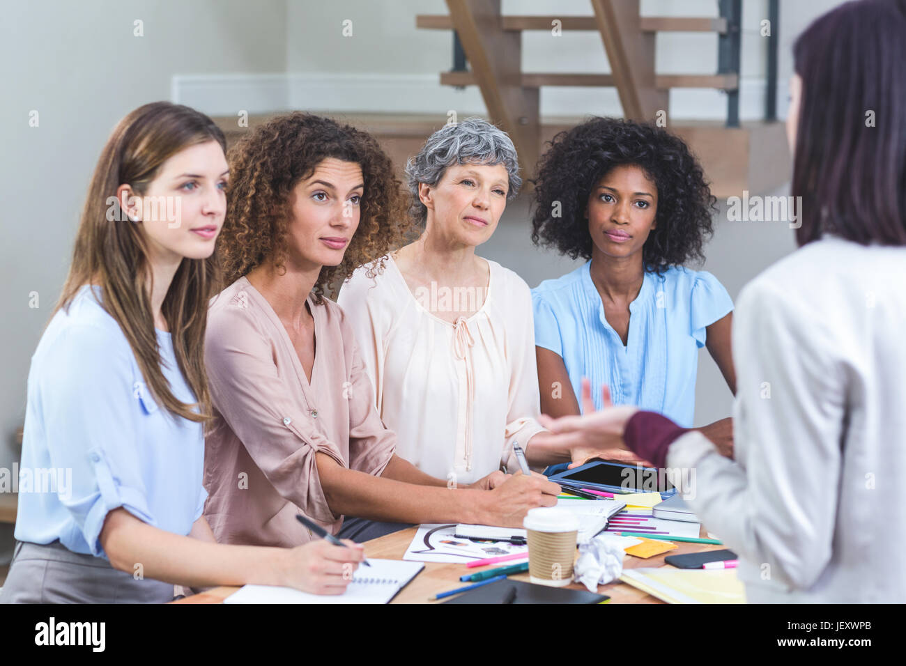 Woman giving presentation to her colleagues Stock Photo - Alamy