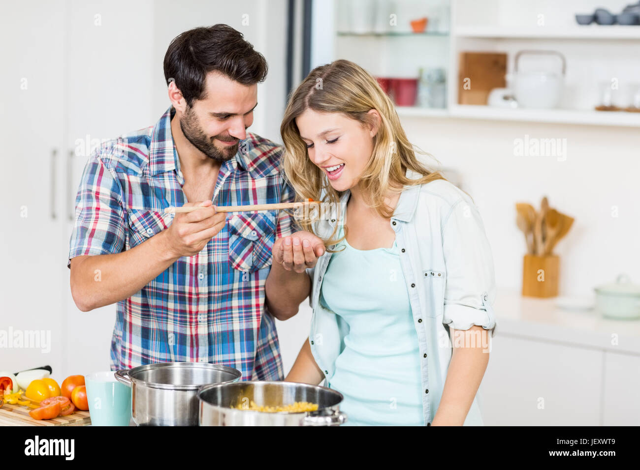 Young couple tasting food Stock Photo - Alamy