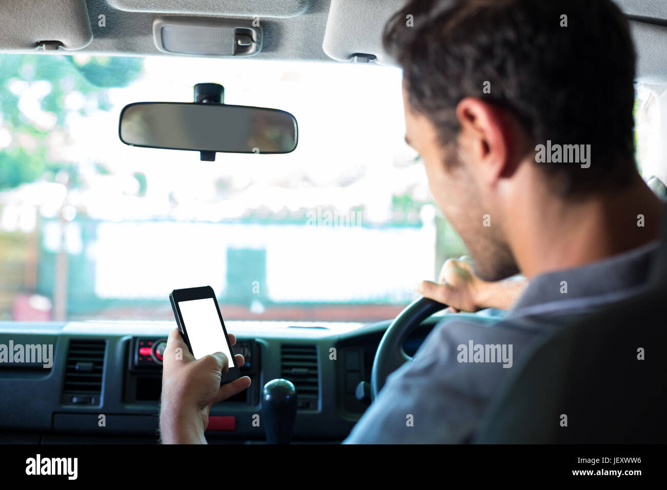 Driver using phone in car Stock Photo - Alamy