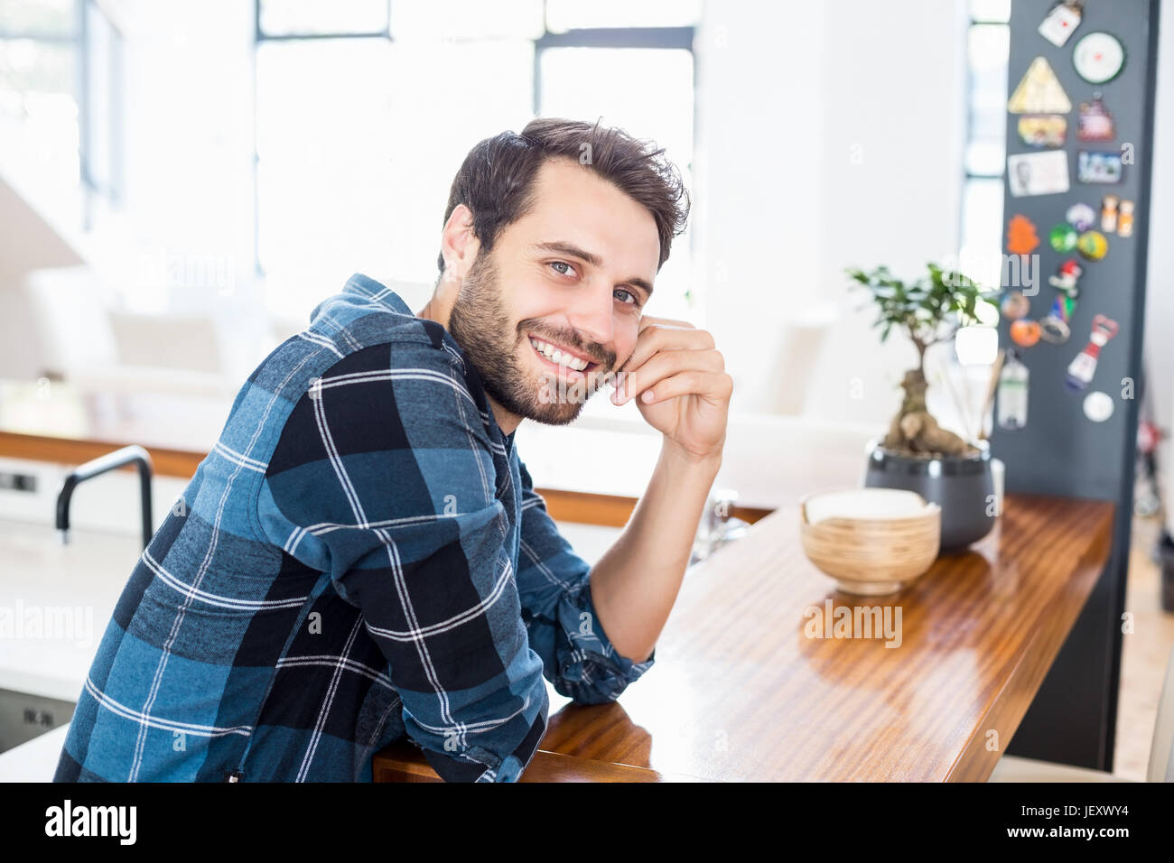 Portrait of happy man leaning on table Stock Photo - Alamy