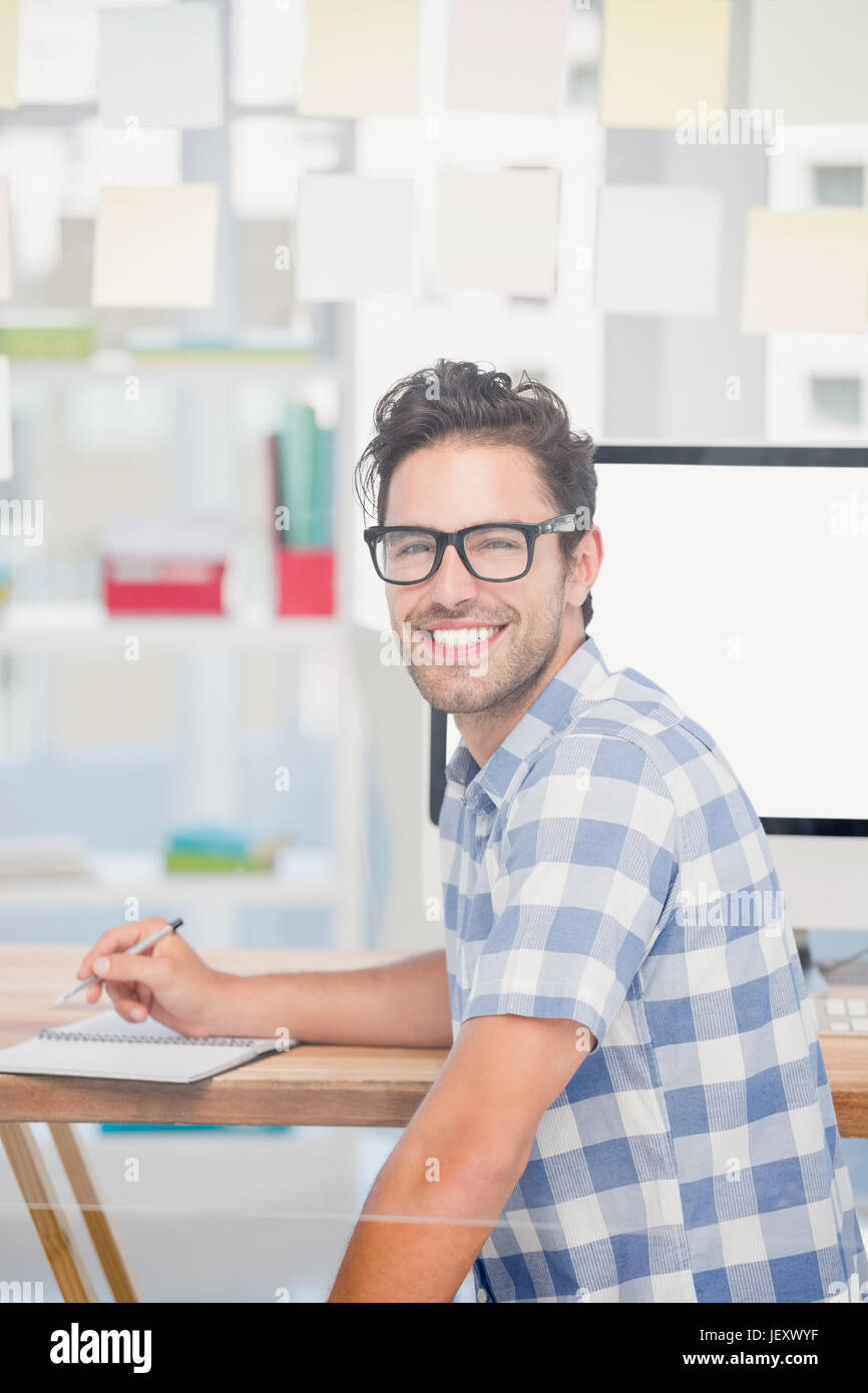 Happy man writing on diary Stock Photo - Alamy