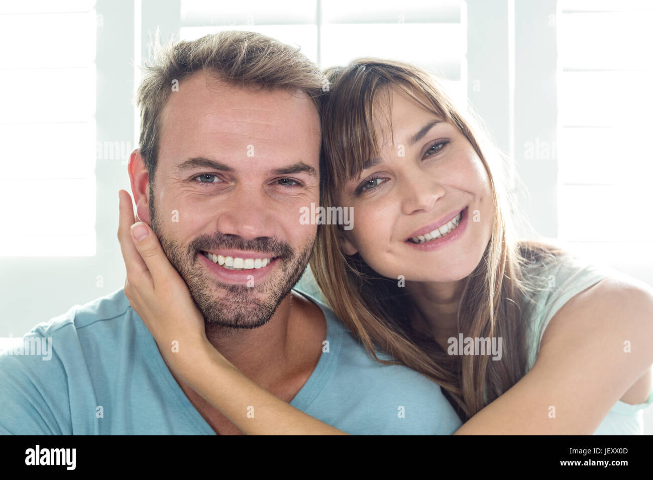 Smiling man sitting against window hi-res stock photography and images ...