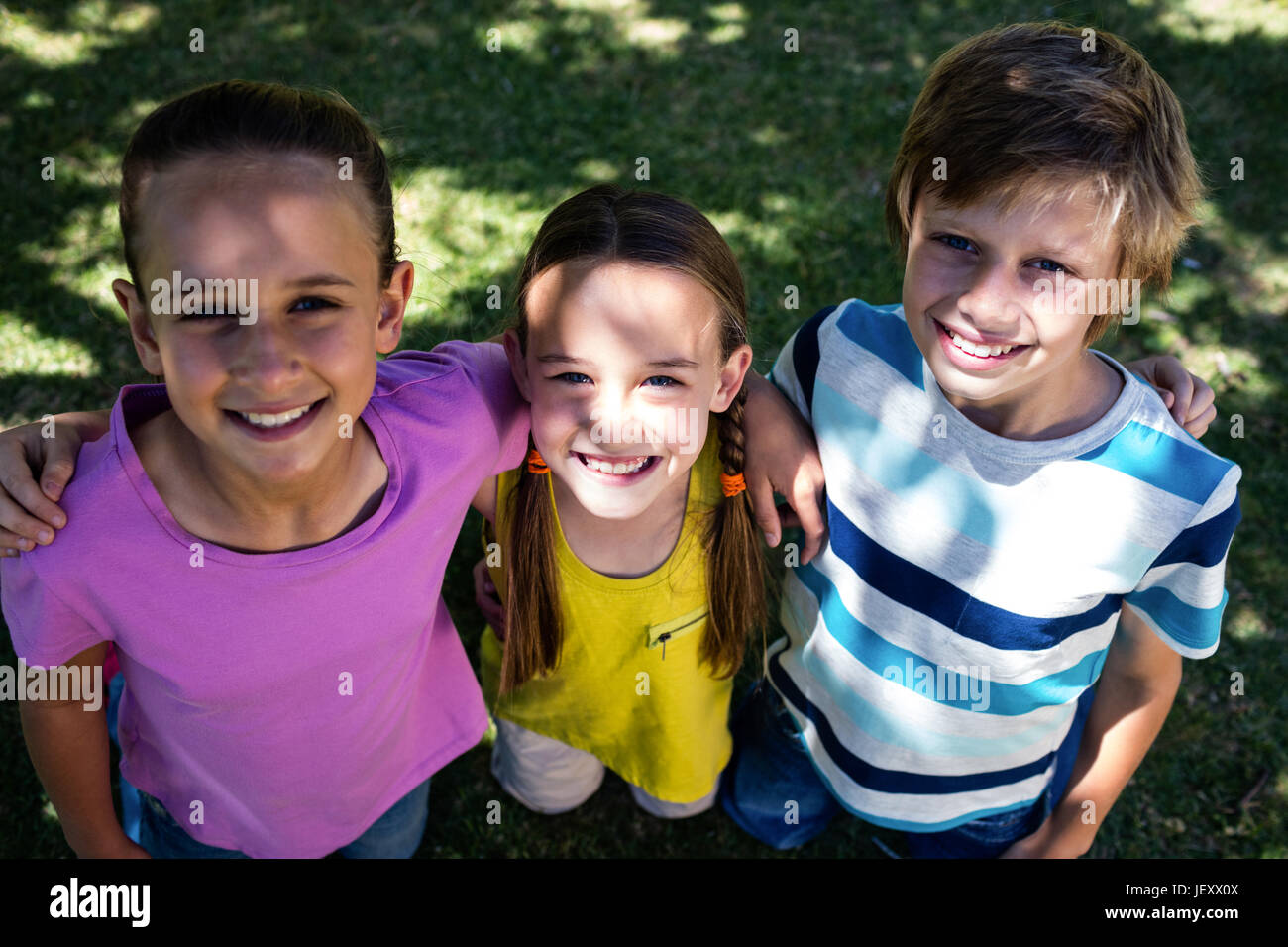 Portrait of happy children standing in park Stock Photo - Alamy