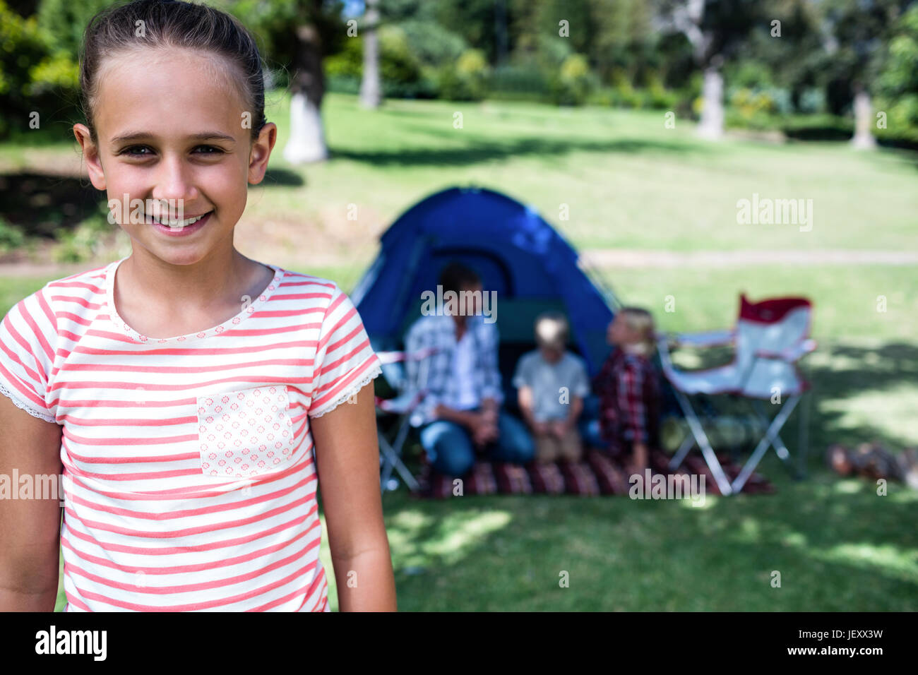 Portrait of a girl standing outside a tent Stock Photo - Alamy