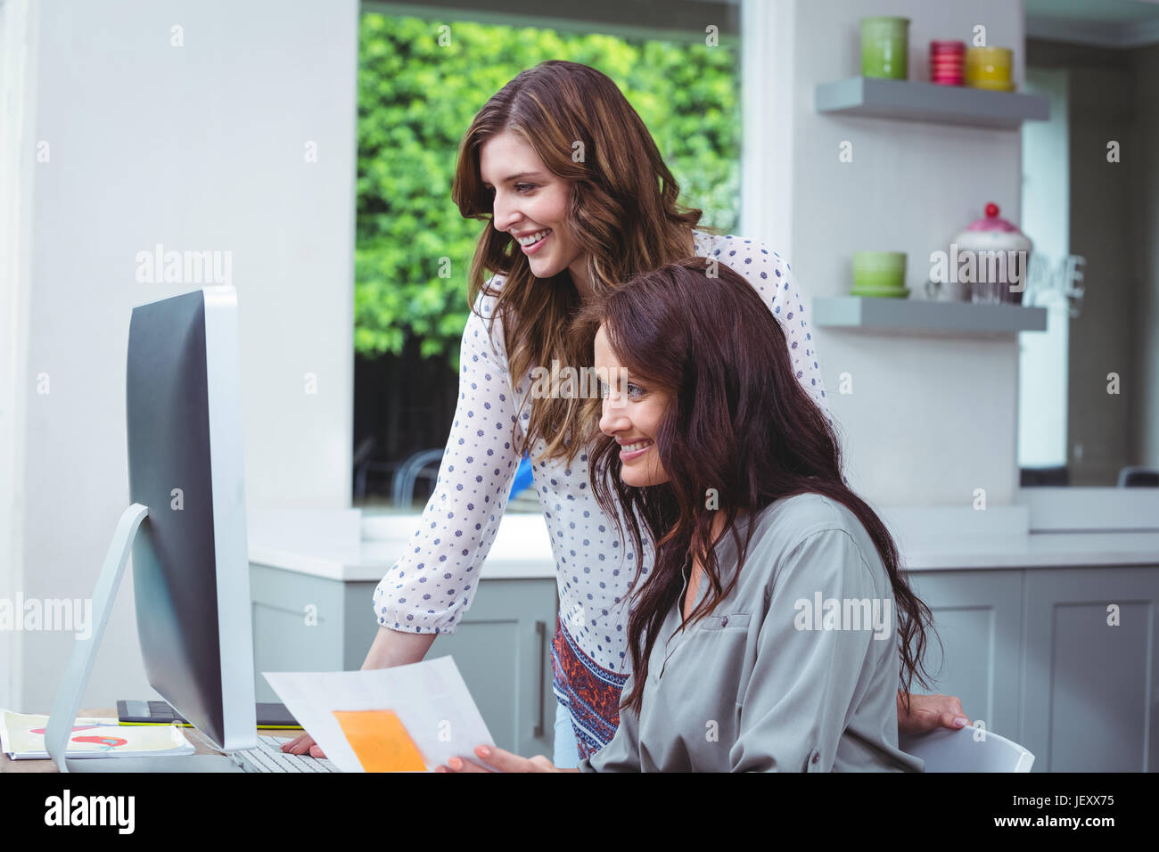 Two beautiful woman using computer Stock Photo - Alamy