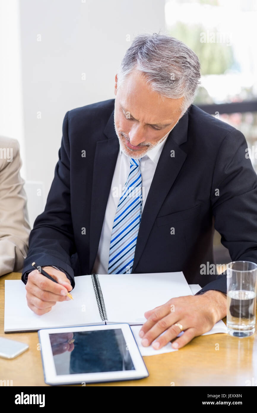 A businessman is taking some notes Stock Photo - Alamy