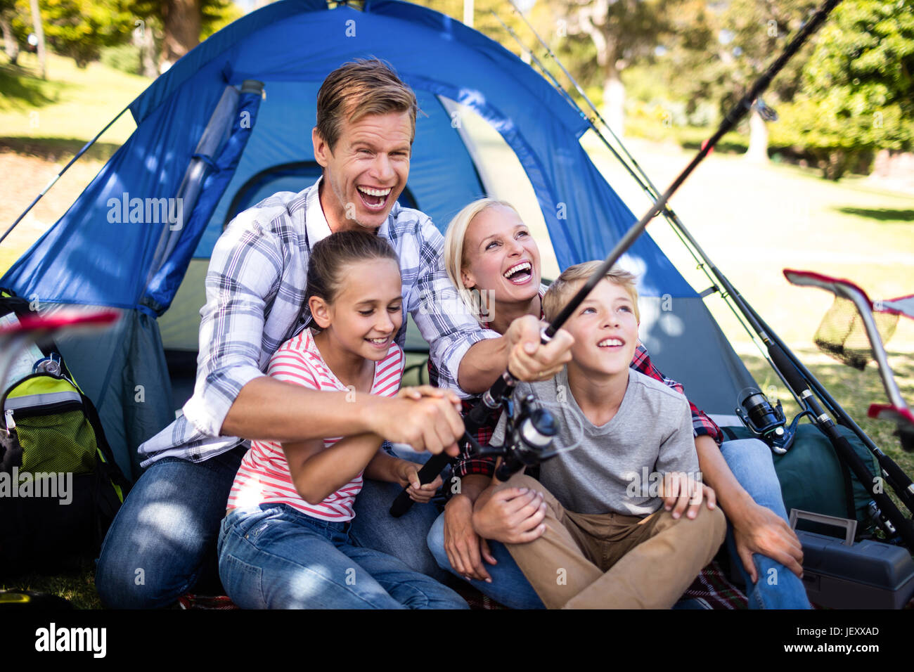 Family fishing outside their tent Stock Photo - Alamy