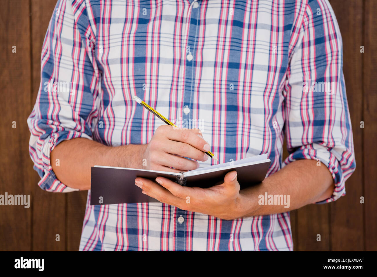 Man writing in a diary Stock Photo - Alamy