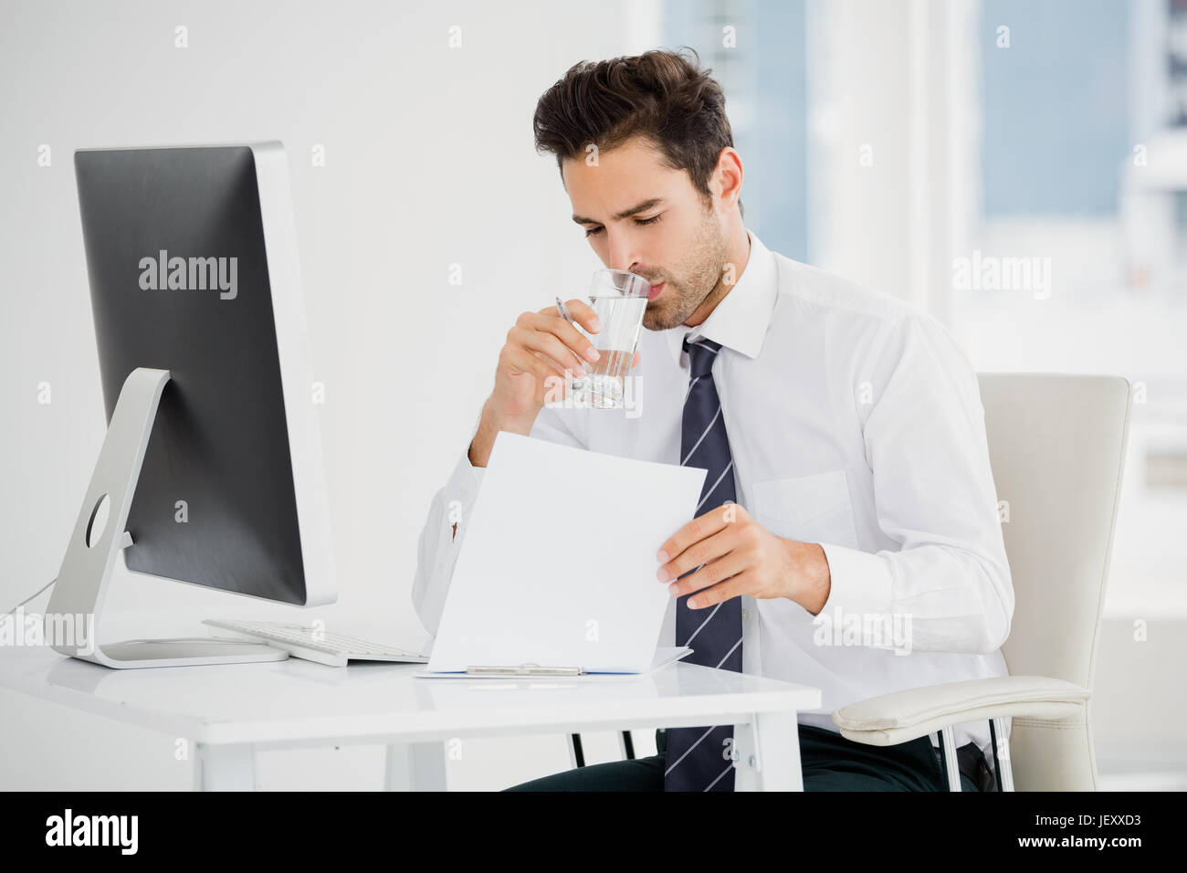 Businessman drinking water at office desk hi-res stock photography and ...