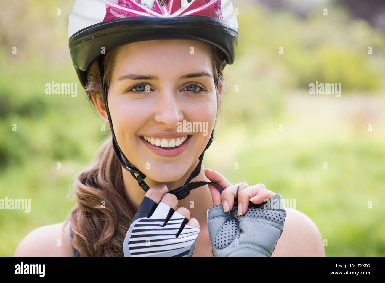Smiling woman wearing a helmet Stock Photo - Alamy