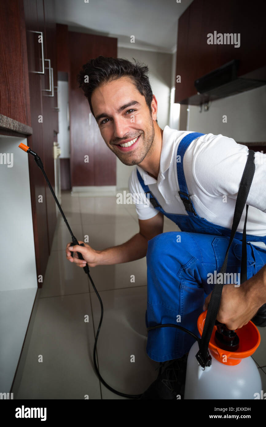 Portrait of smiling man with insecticide Stock Photo - Alamy
