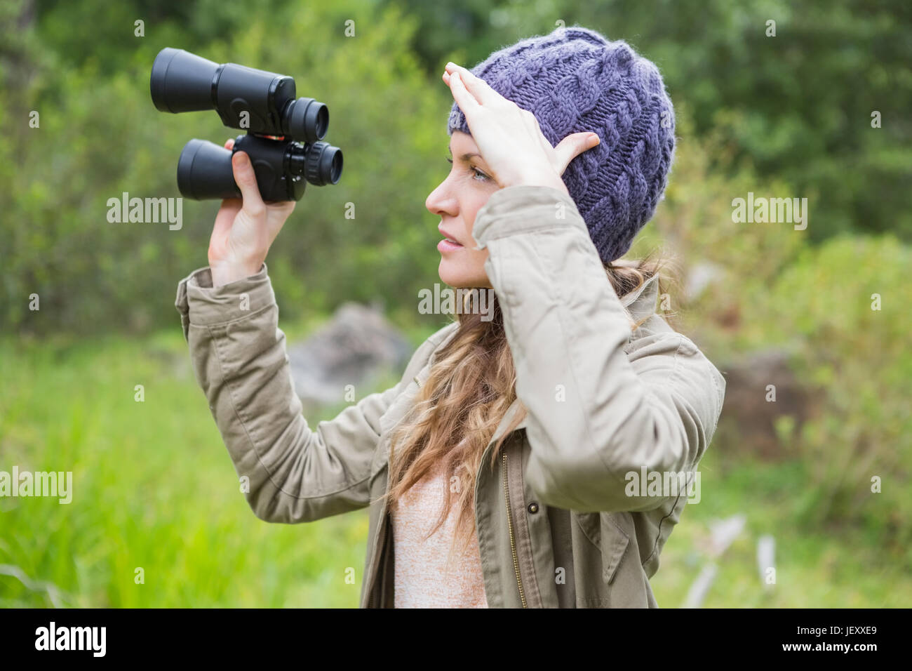 Woman using binoculars Stock Photo - Alamy