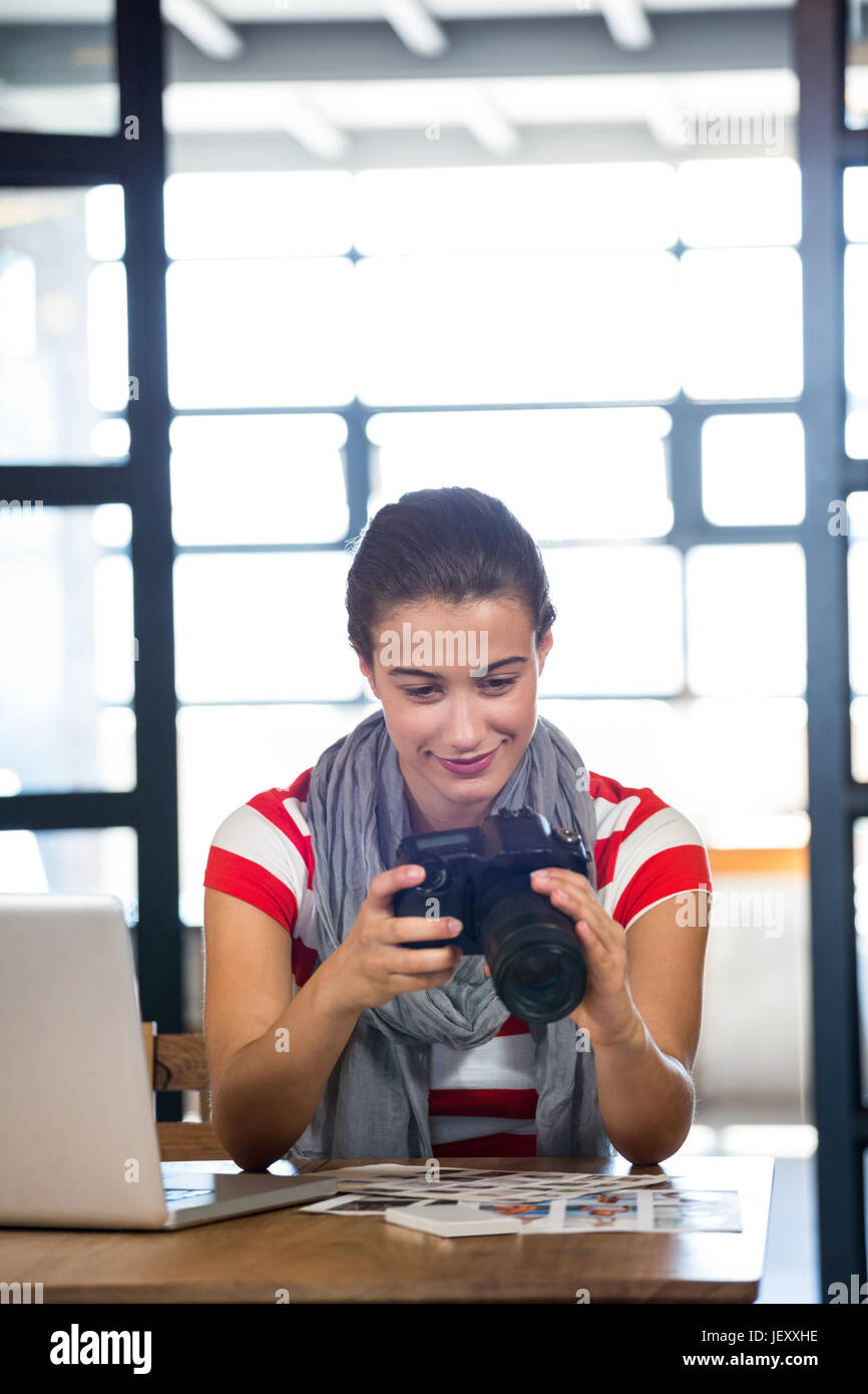 Woman checking photo in camera Stock Photo - Alamy