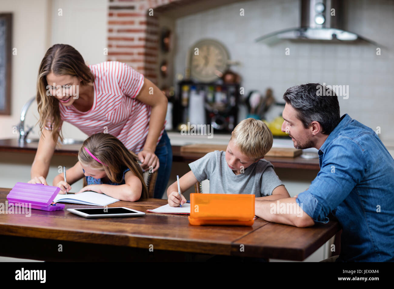 Parents helping the kids with their homework Stock Photo - Alamy