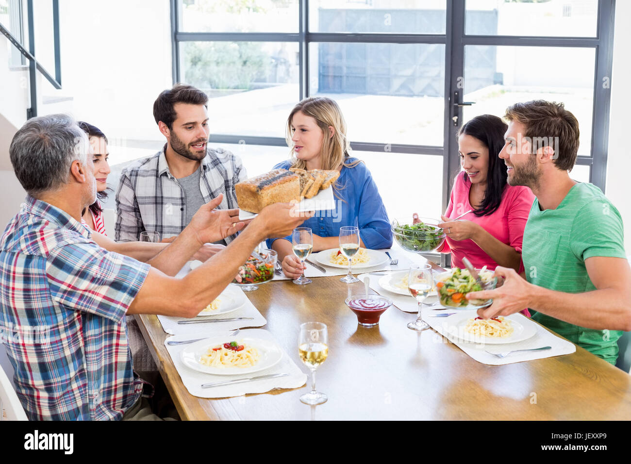 Friends interacting while having a meal Stock Photo - Alamy