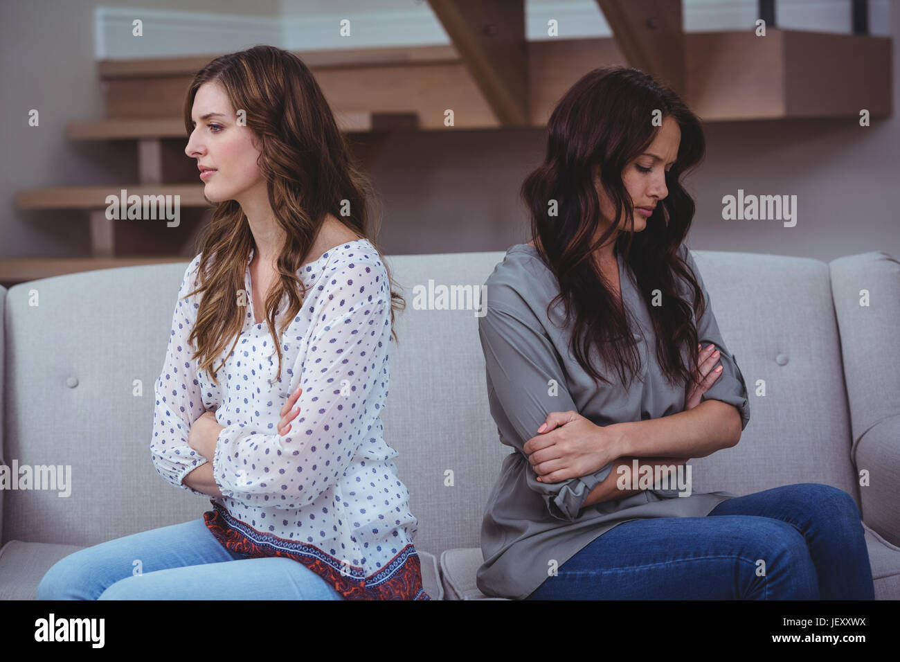 Woman ignoring her friend after an argument Stock Photo - Alamy