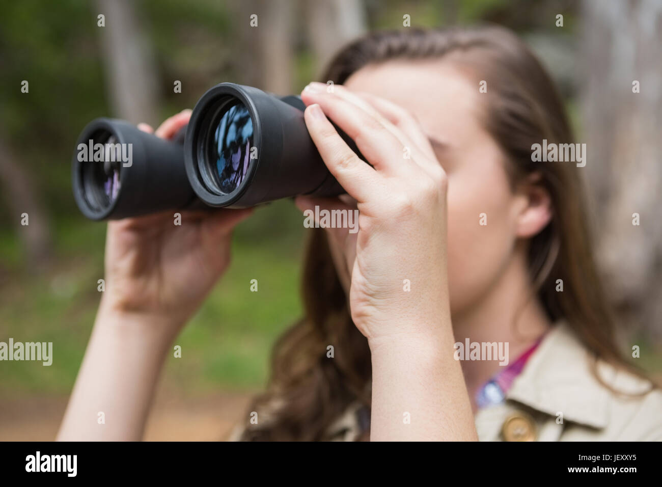 Woman using binoculars Stock Photo - Alamy