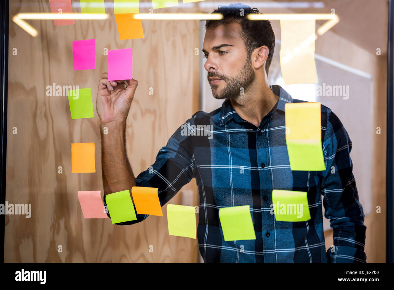 Man writing on sticky notes Stock Photo - Alamy