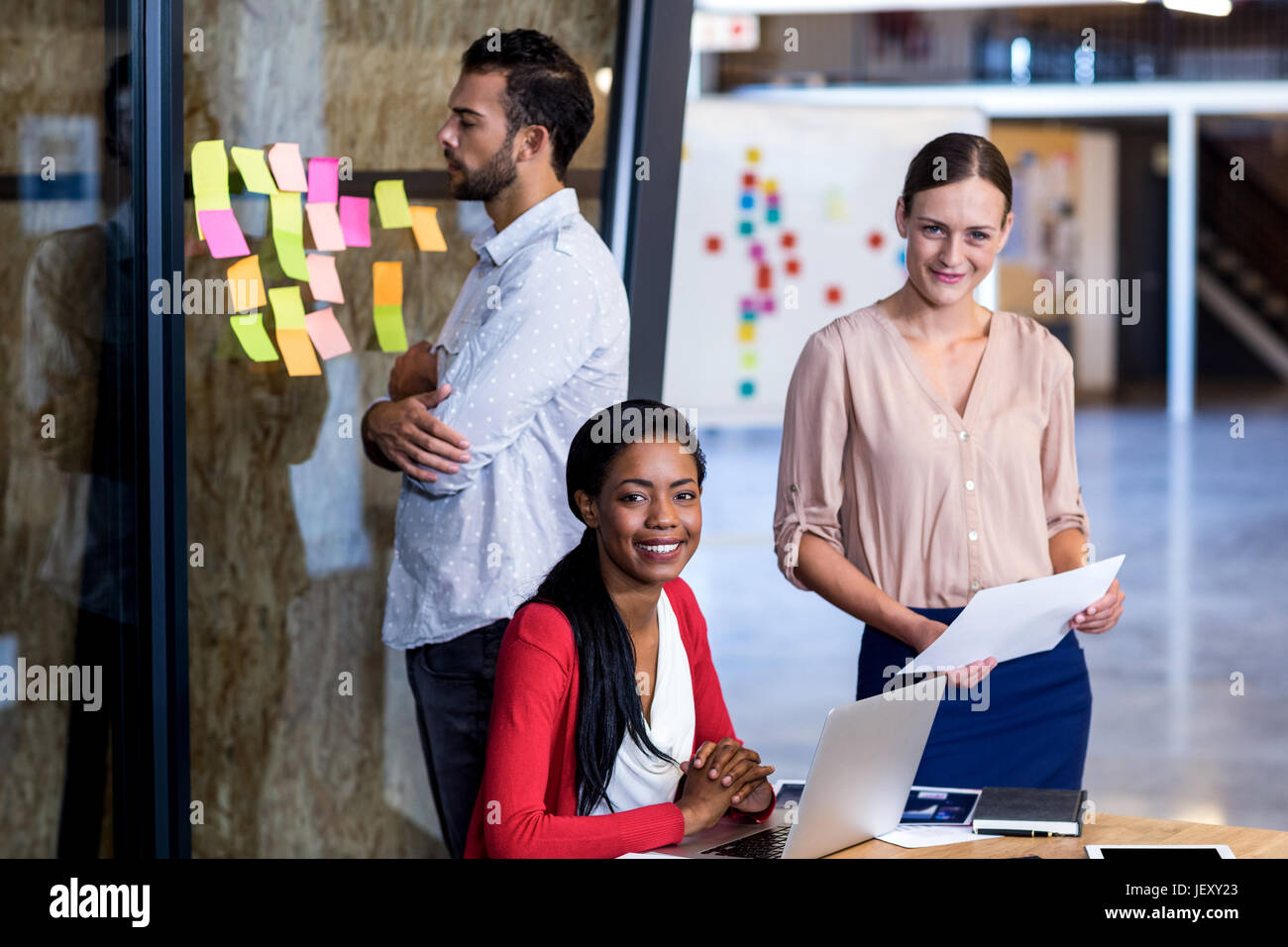 Team of colleagues at their desk Stock Photo - Alamy