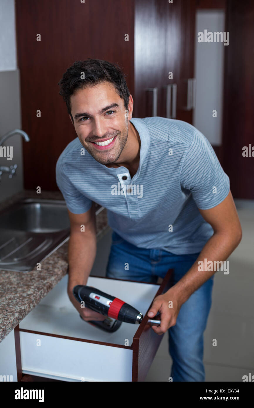 Young worker using drill hi-res stock photography and images - Alamy