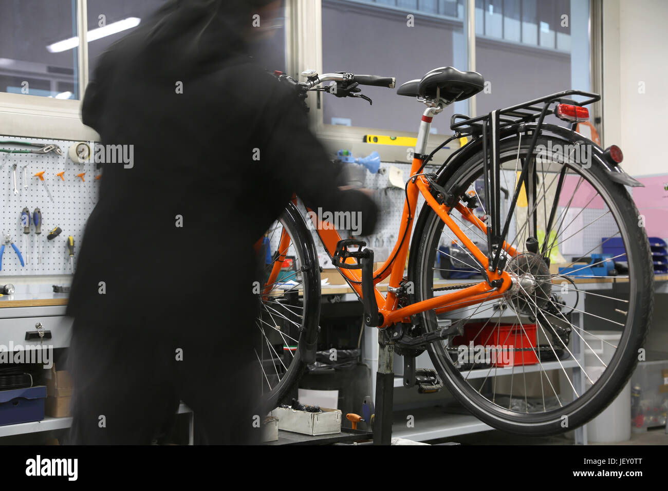 Mechanic while repairing the bicycle inside the mechanical workshop ...