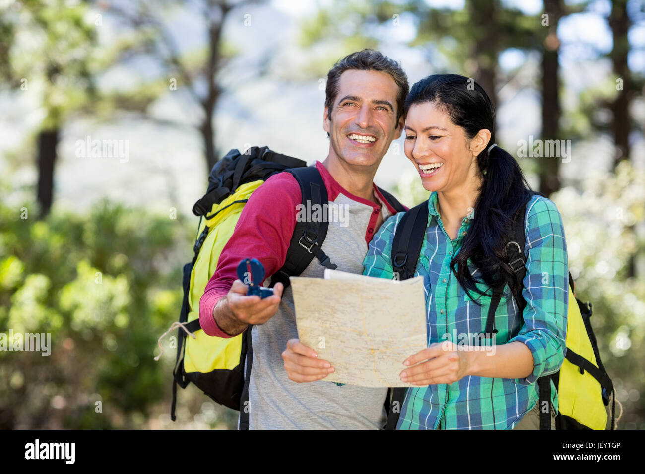 Couple smiling and holding a map Stock Photo - Alamy