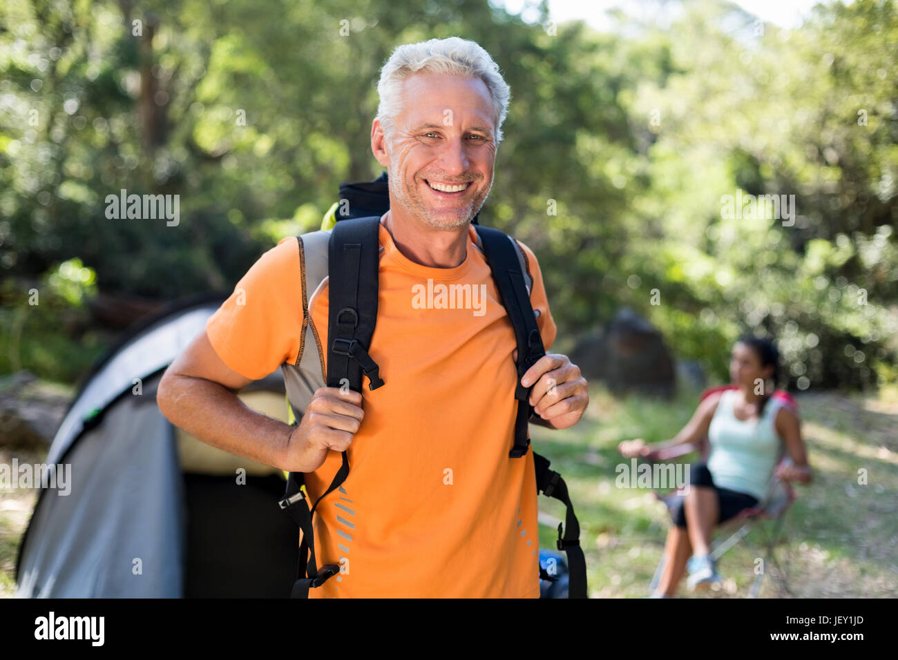 Man smiling and posing with his backpack Stock Photo - Alamy