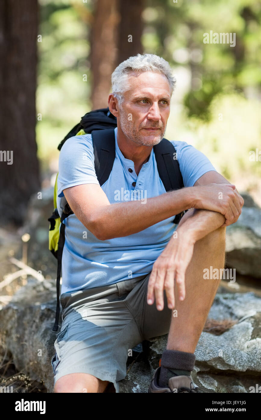 Hiker sitting on a rock Stock Photo - Alamy