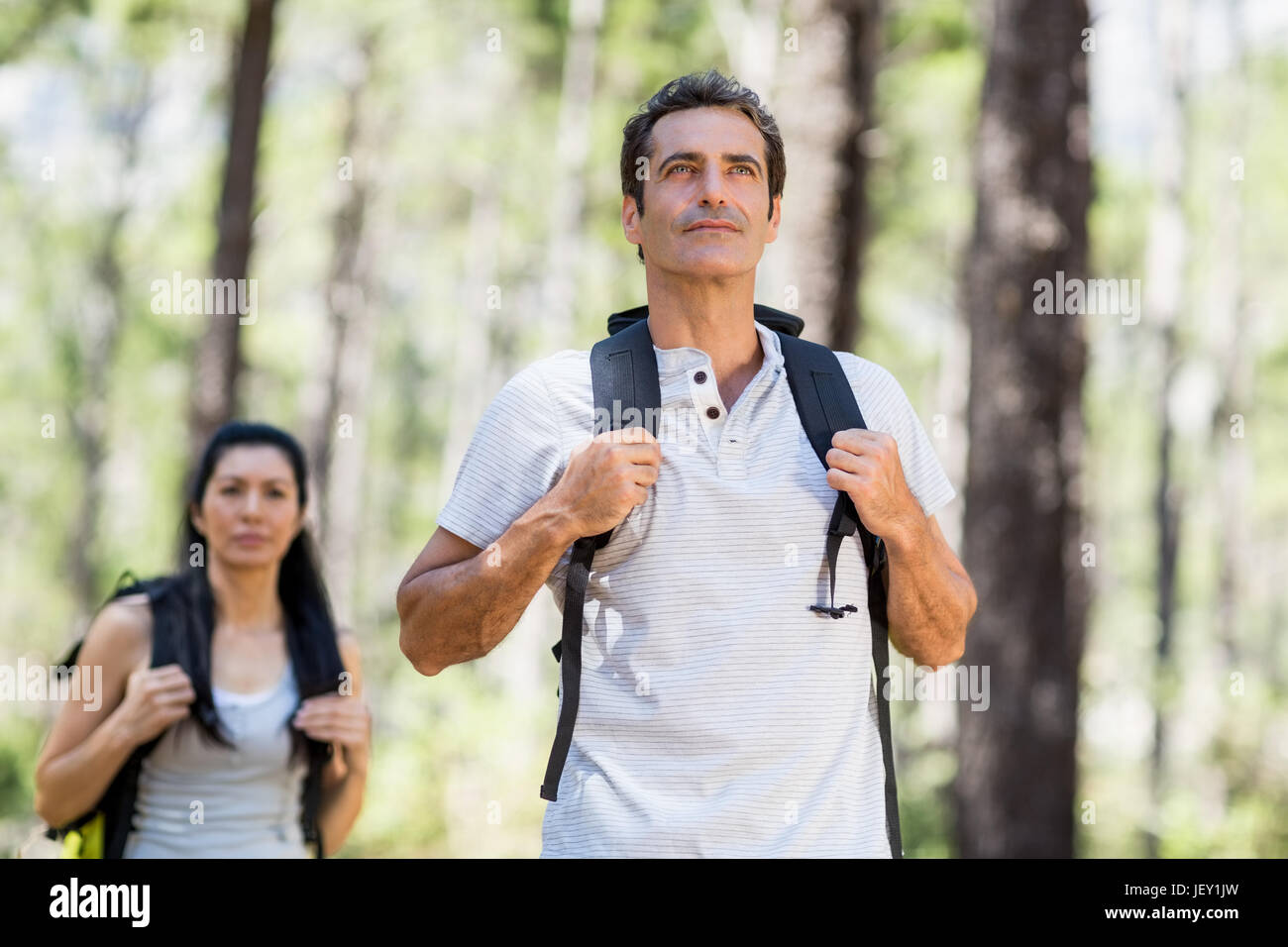 Couple posing with backpack Stock Photo - Alamy