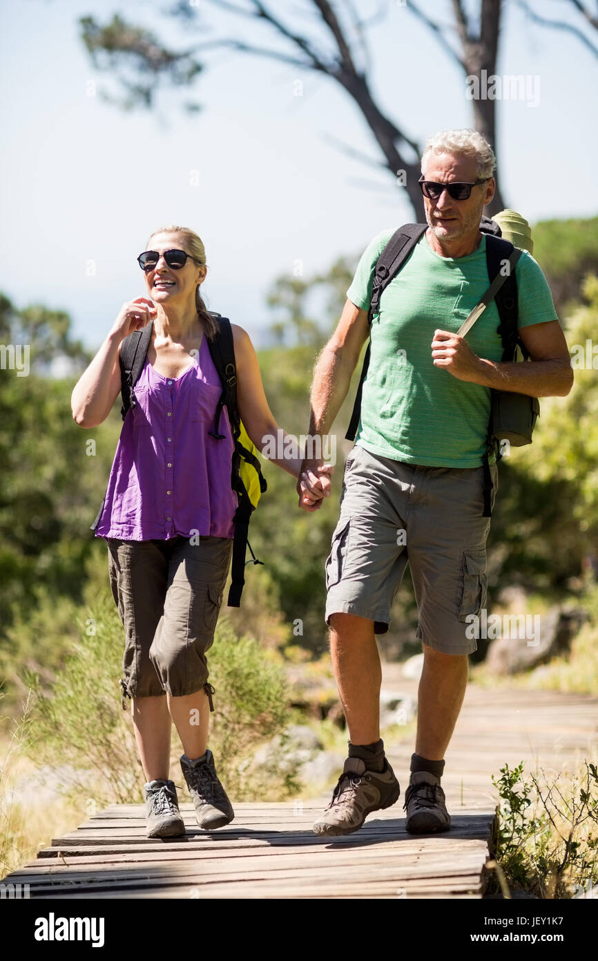 Couple hiking and holding hands each other Stock Photo - Alamy