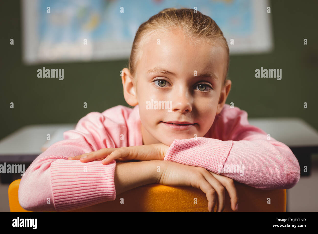 Girl leaning against chair Stock Photo - Alamy