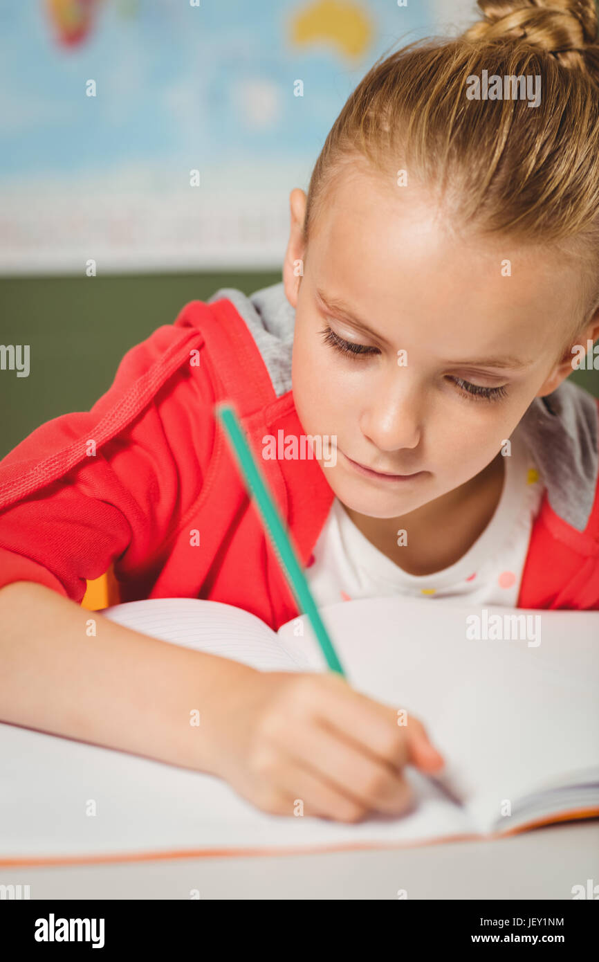 Girl writing in her notebook Stock Photo - Alamy