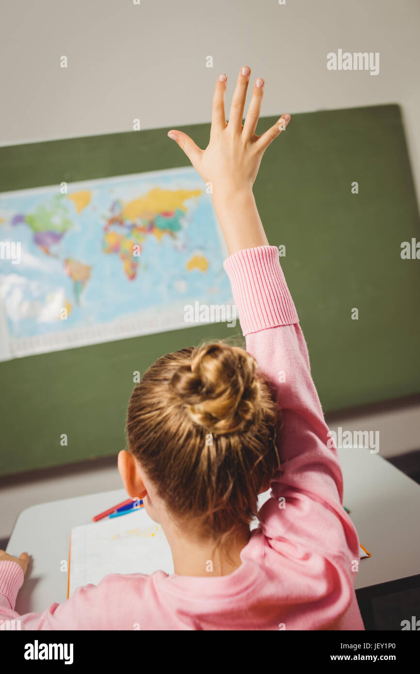 Girl raising her hand Stock Photo - Alamy