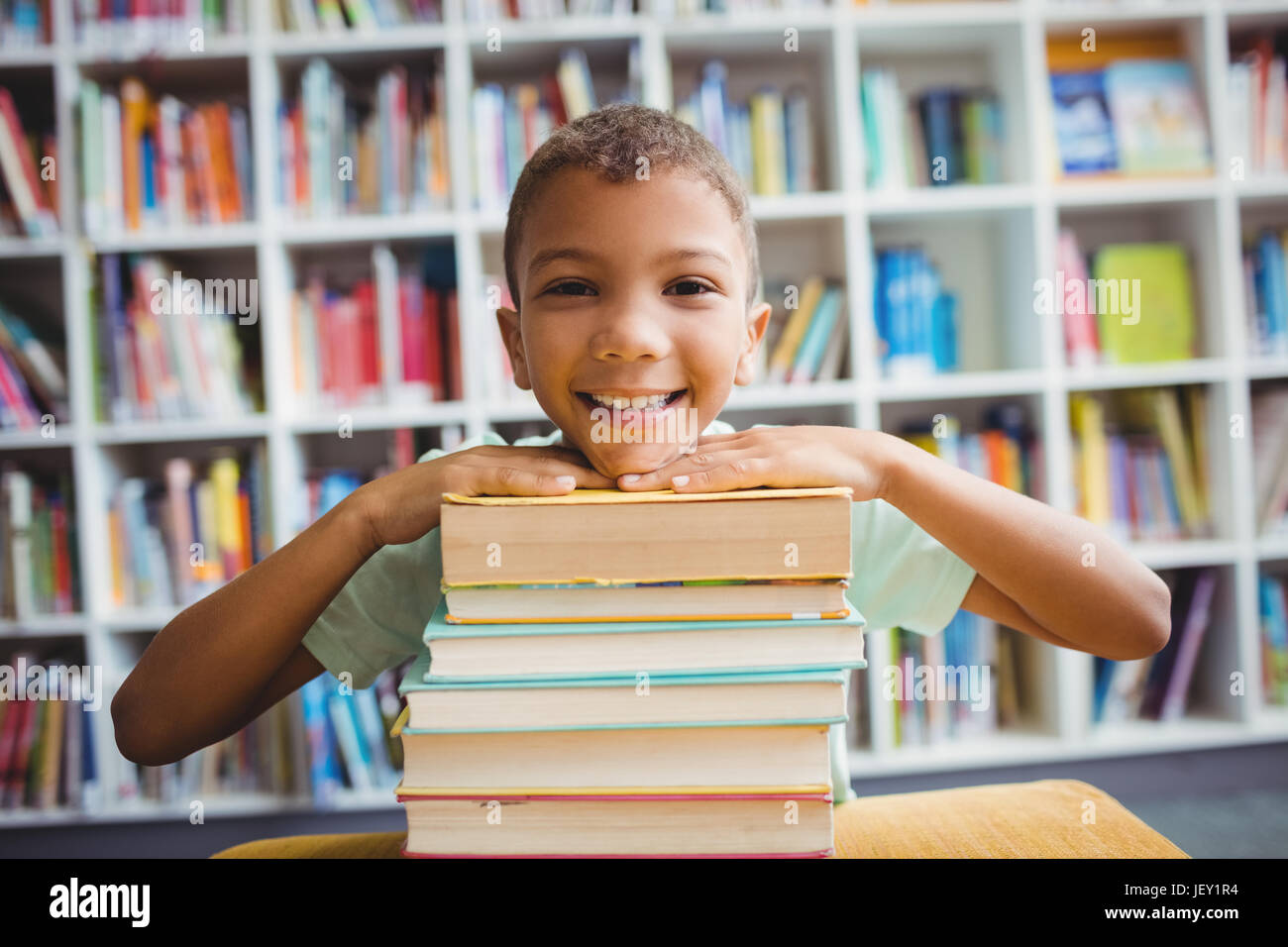 Boy putting his head on books Stock Photo - Alamy