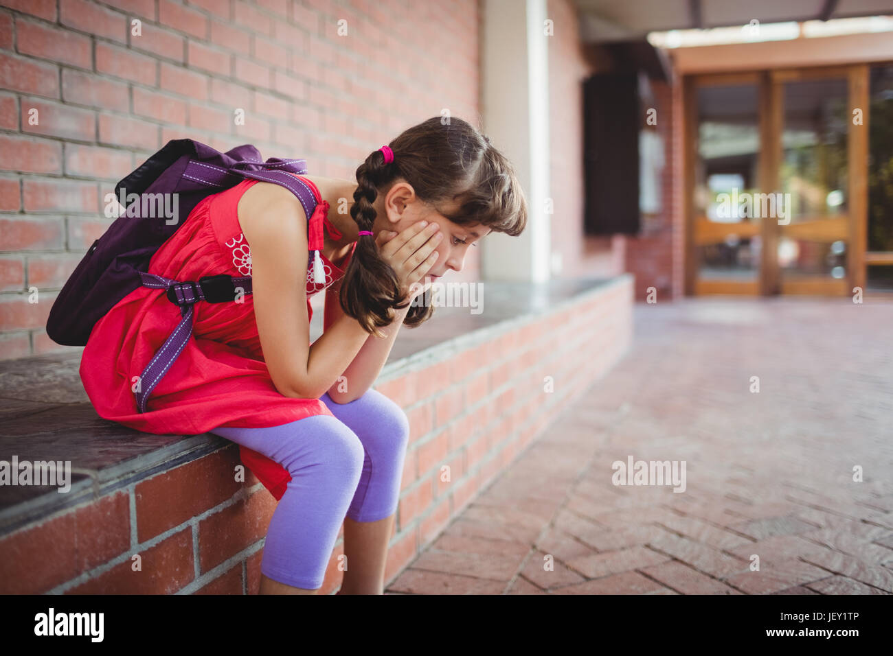 Girl holding her cheek Stock Photo - Alamy
